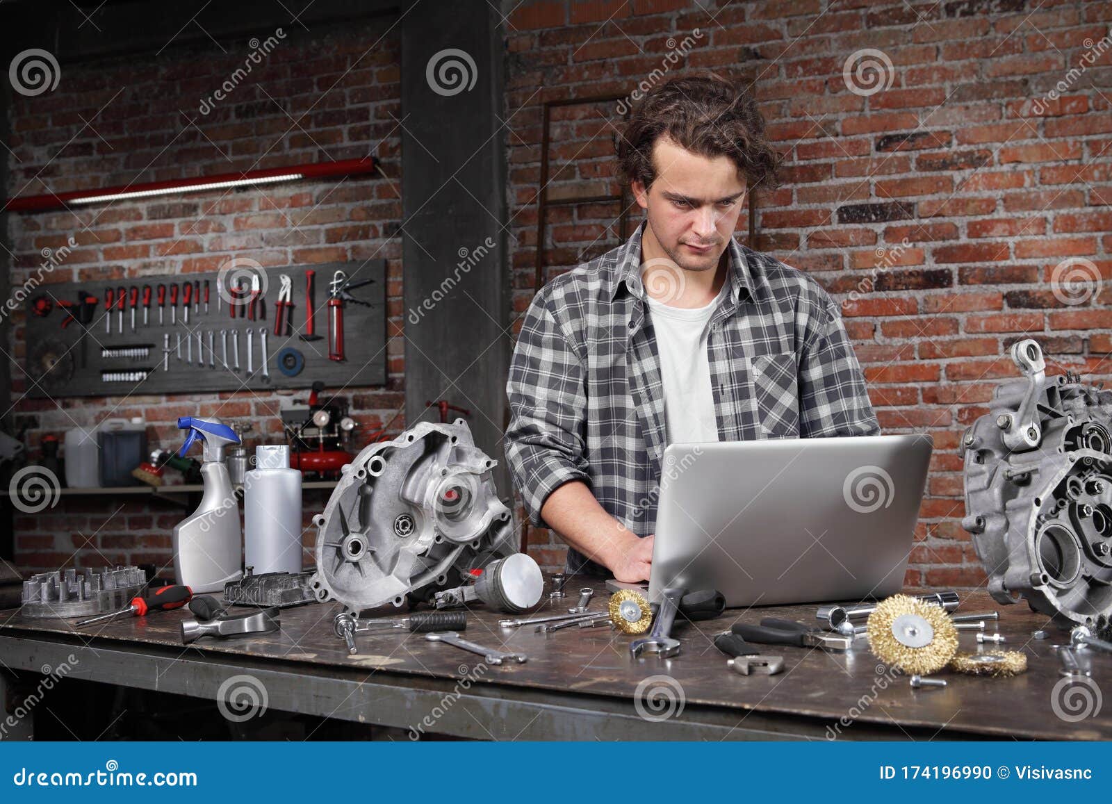 Man Work with Computer Search in Internet Spare Engine Parts on the ...