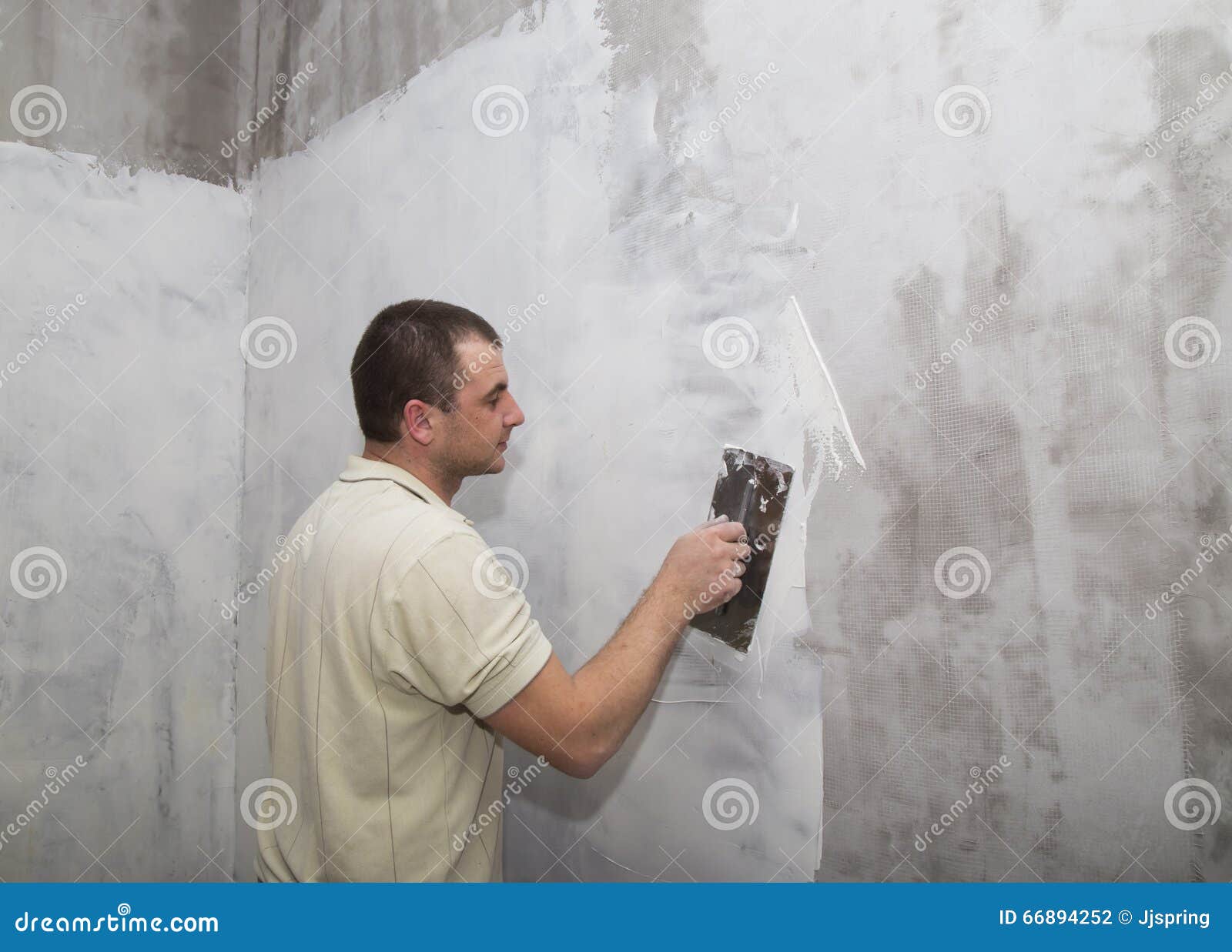 Man Worker Applying First Layer Of Putty With Trowel Stock Photo ...