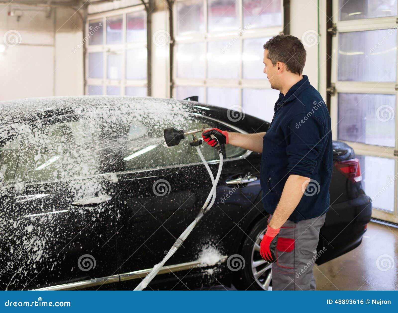 Man worker on a car wash stock photo. Image of washing - 48893616