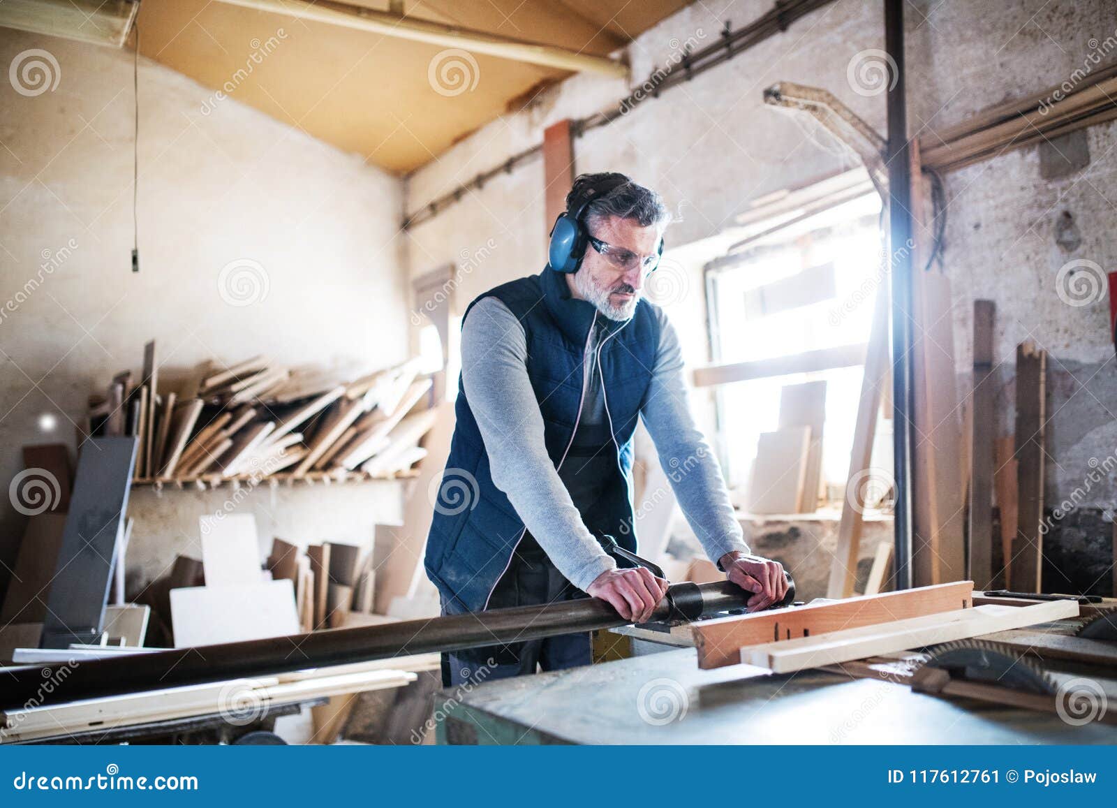 A Man Worker in the Carpentry Workshop, Working with Wood. Stock Image ...