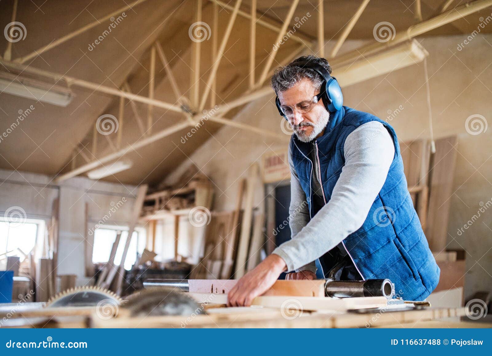 A Man Worker in the Carpentry Workshop, Working with Wood. Stock Photo ...