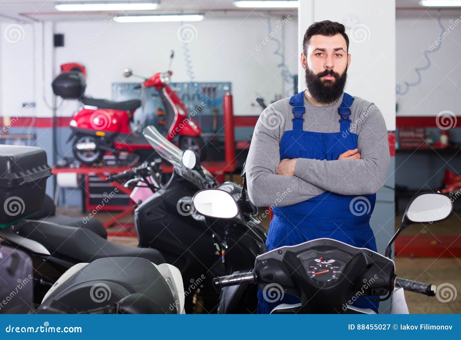 Man Worker Displaying Various Motorcycles in Workshop Stock Image ...