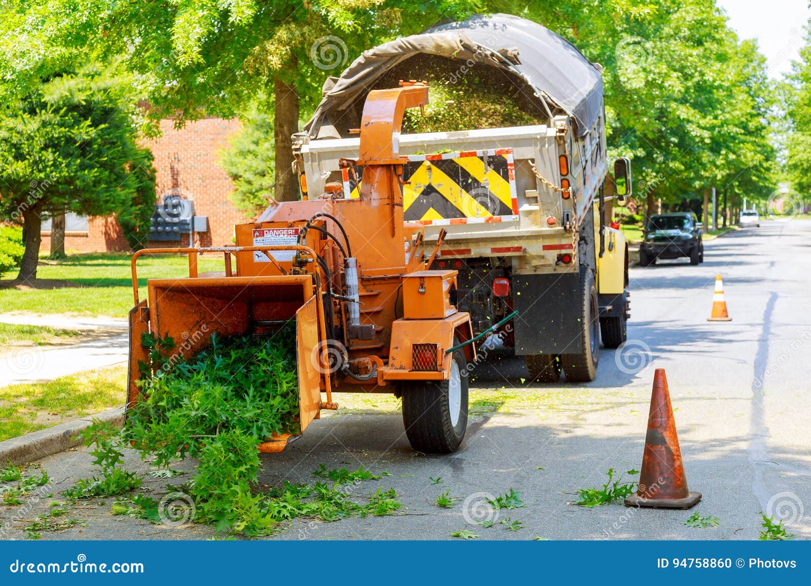 Man Worker Feeds Large Branch into Wood Chipper Stock Photo - Image of ...