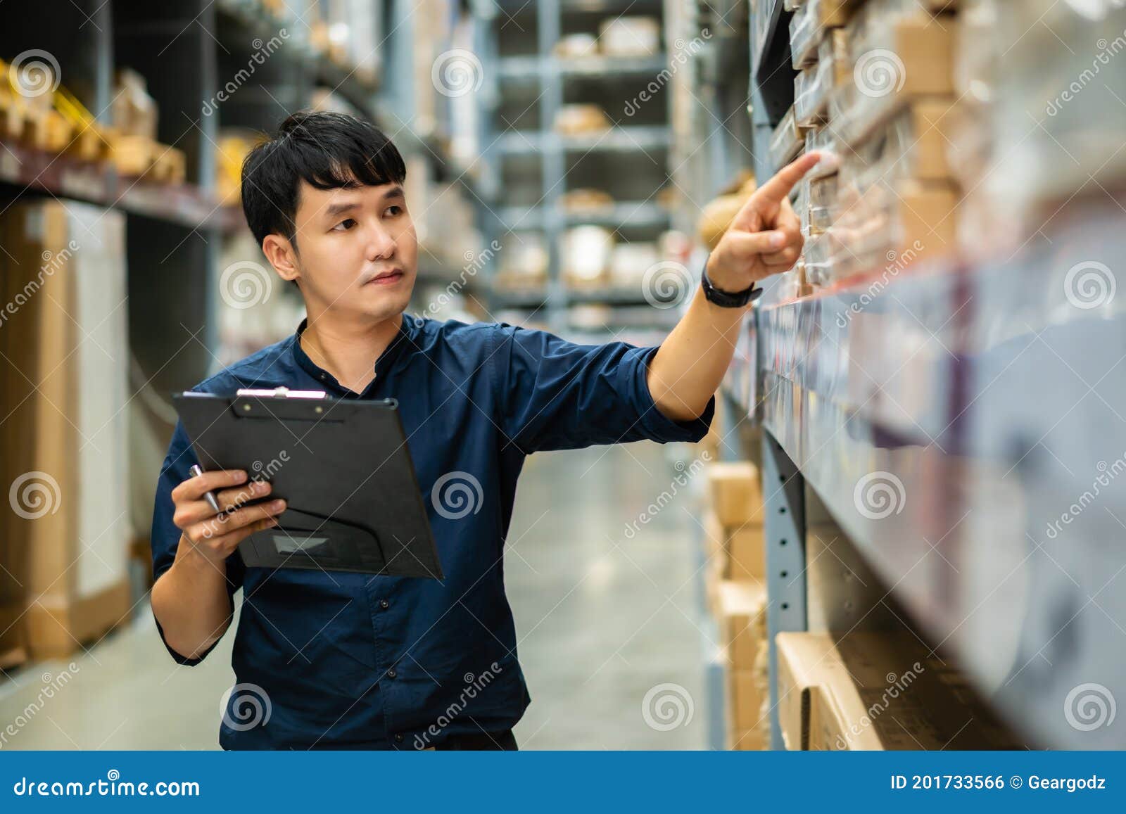 Man Worker Holding Clipboard and Checking Inventory in the Warehouse ...