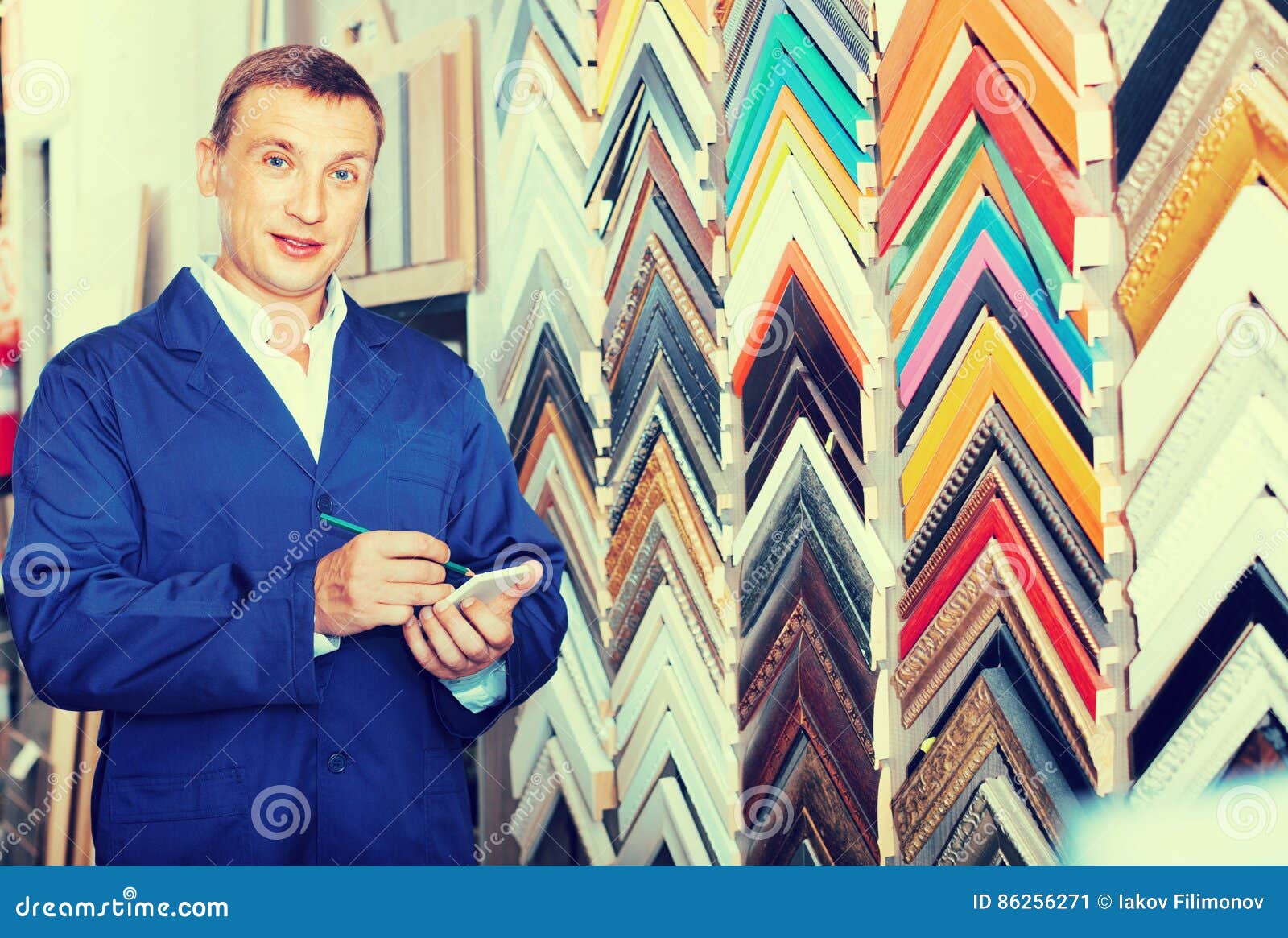 Man Worker Holding Picture Frame Details on Counter Stock Image - Image ...