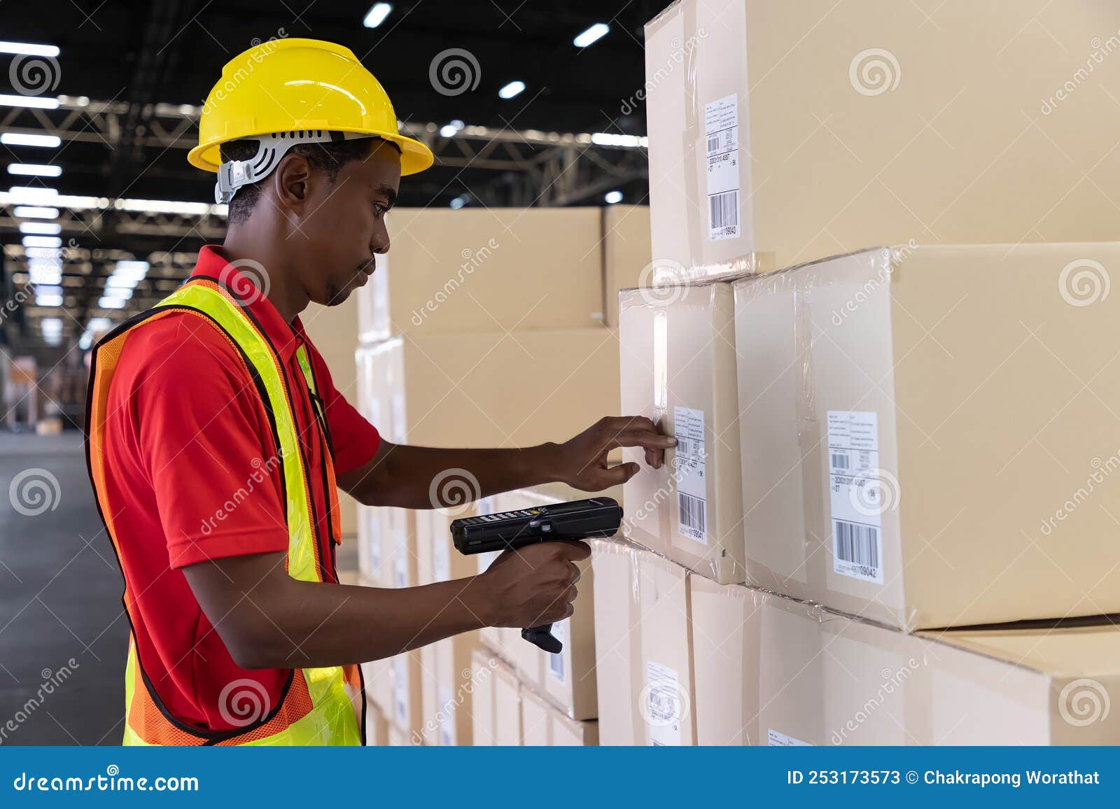 A Man Worker Scanning Package with Warehouse Barcode Scanner in Modern ...