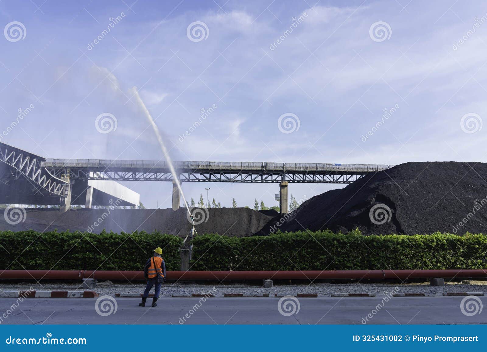 A Man Worker Spray Water at Coal Pile. Stock Photo - Image of spraying ...
