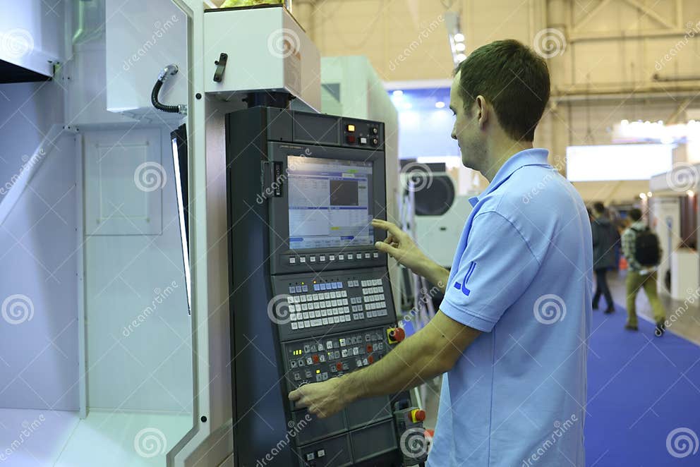 Man Worker Working with a Control Panel of a CNC Milling Machine, Stand ...