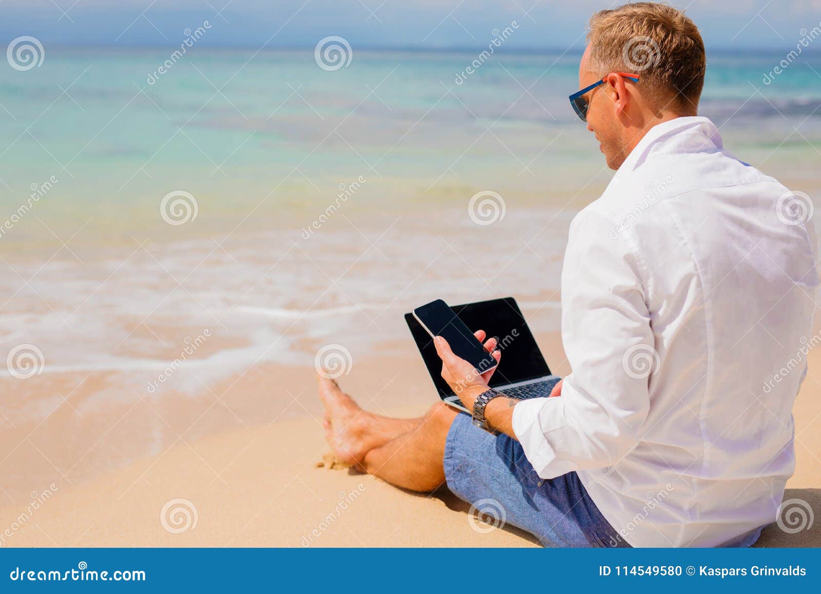 Man working on the beach stock photo. Image of handsome - 114549580