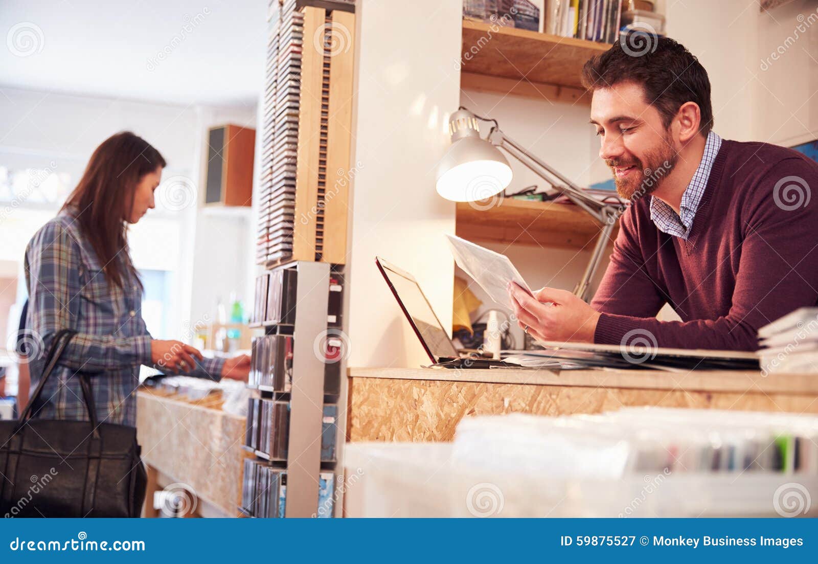 Man Working Behind the Counter at a Record Shop Stock Image - Image of ...