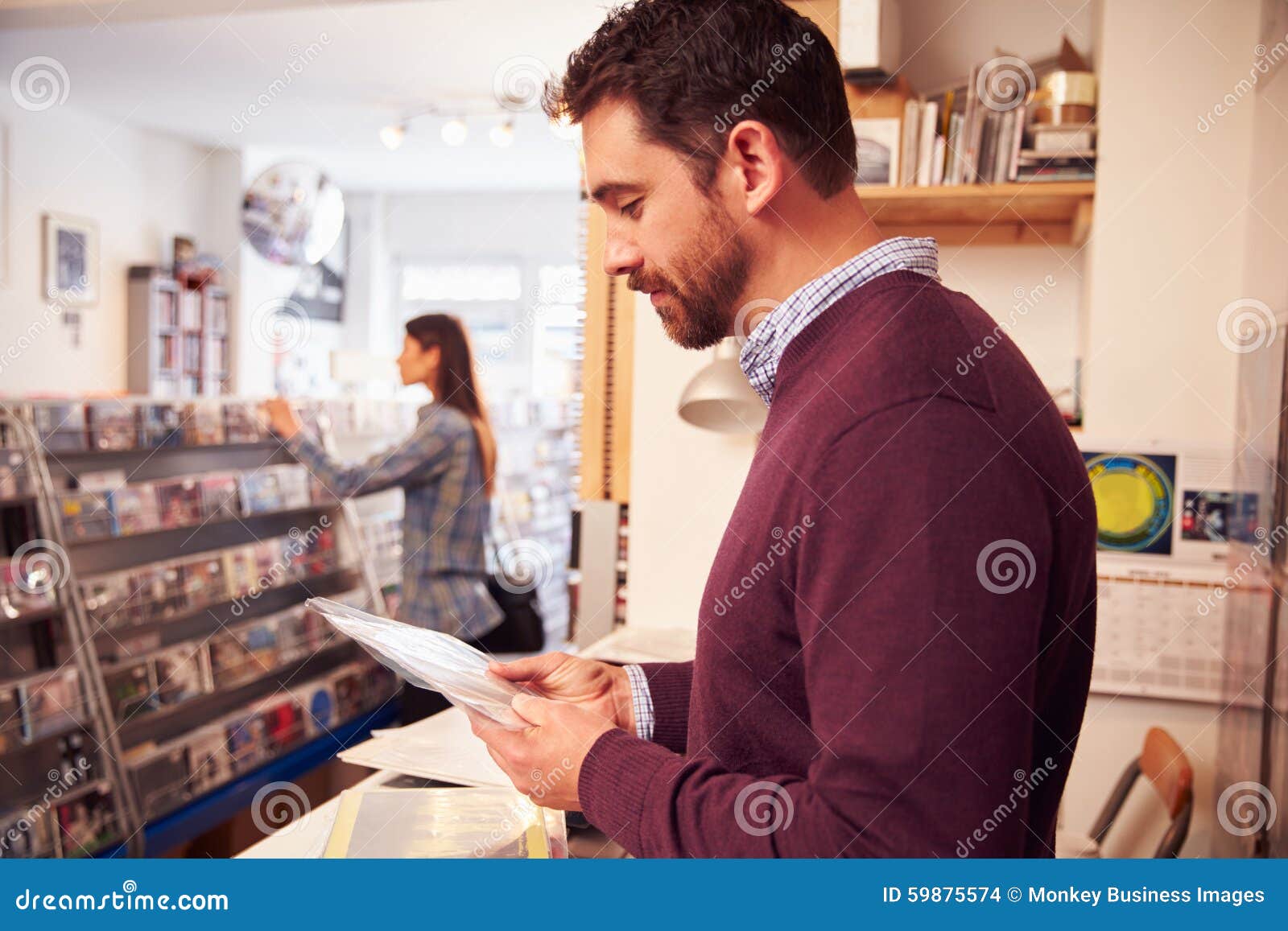 Man Working Behind the Counter at a Record Shop Stock Photo - Image of ...