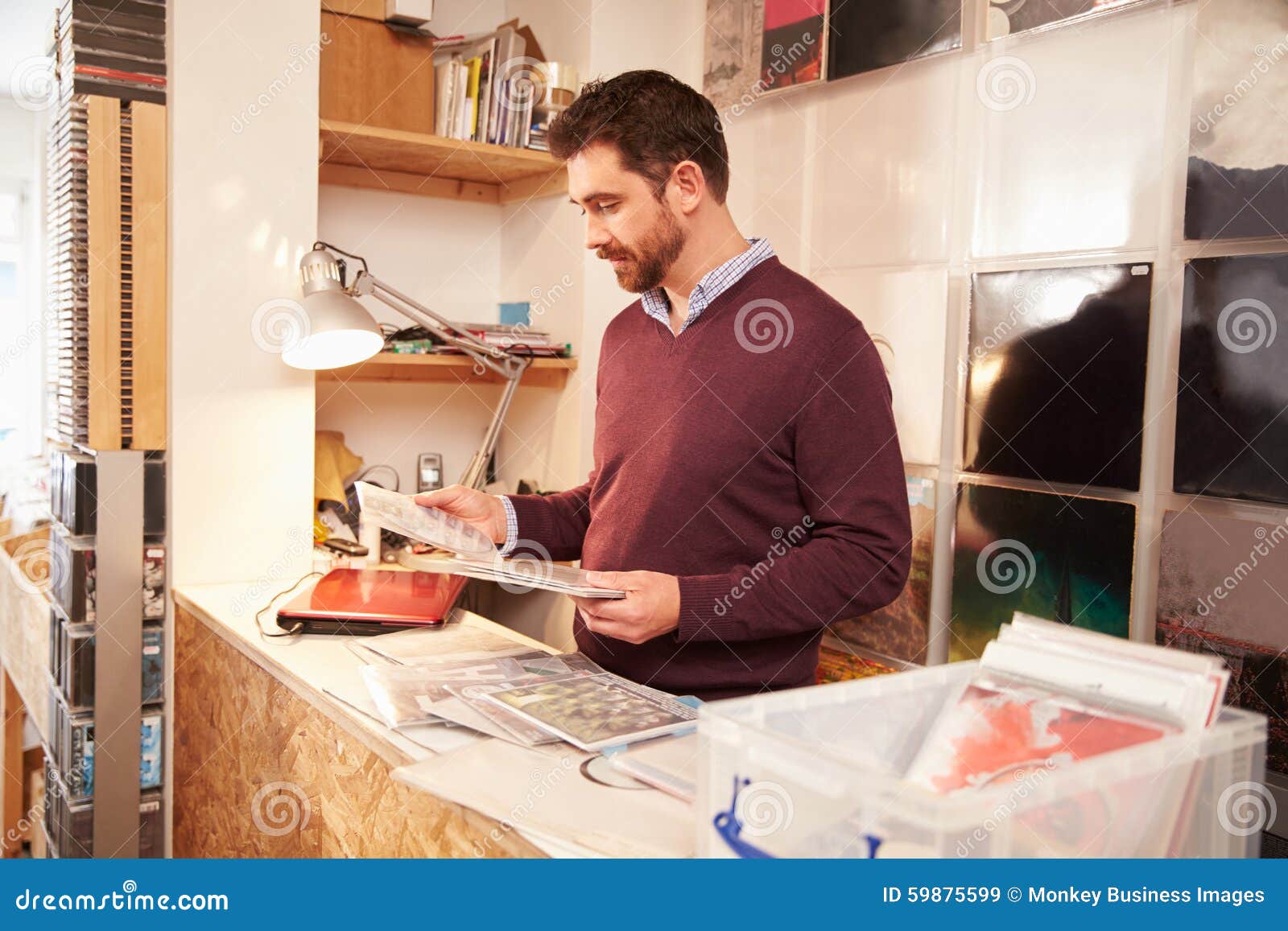 Man Working Behind the Counter at a Record Shop, Portrait Stock Image ...