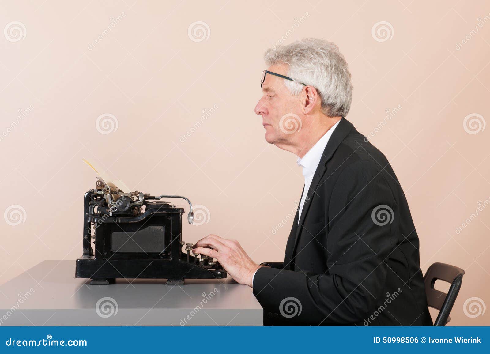 Man Working with Black Typewriter Stock Photo - Image of paper, gray ...