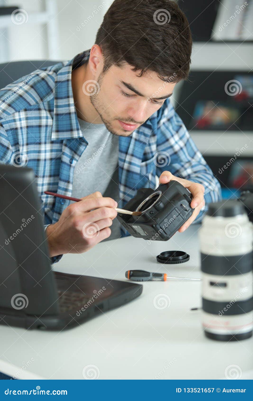 Man working on camera body stock image. Image of desk - 133521657