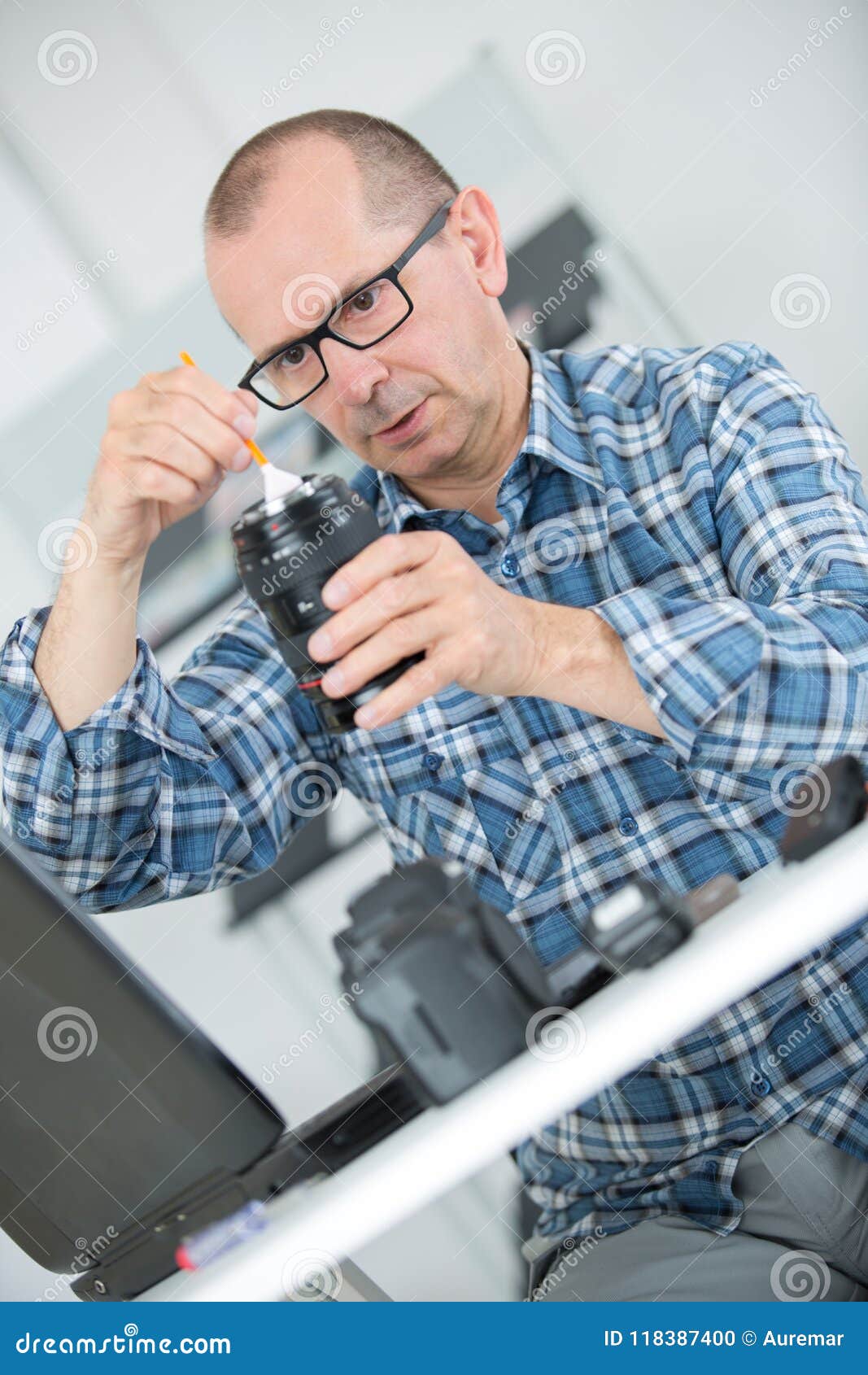 Man working on camera lens stock photo. Image of hand - 118387400