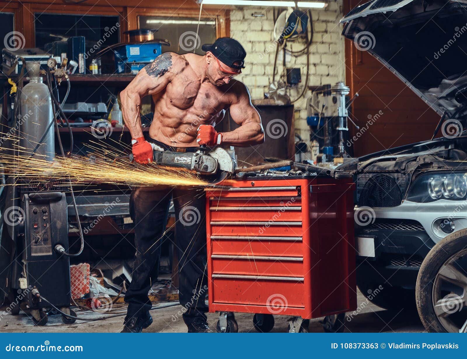 A man in a garage. stock image. Image of construction - 108373363