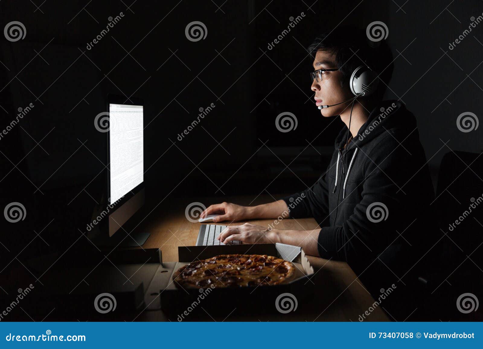 Man Working with Computer and Eating Pizza in Dark Room Stock Photo ...
