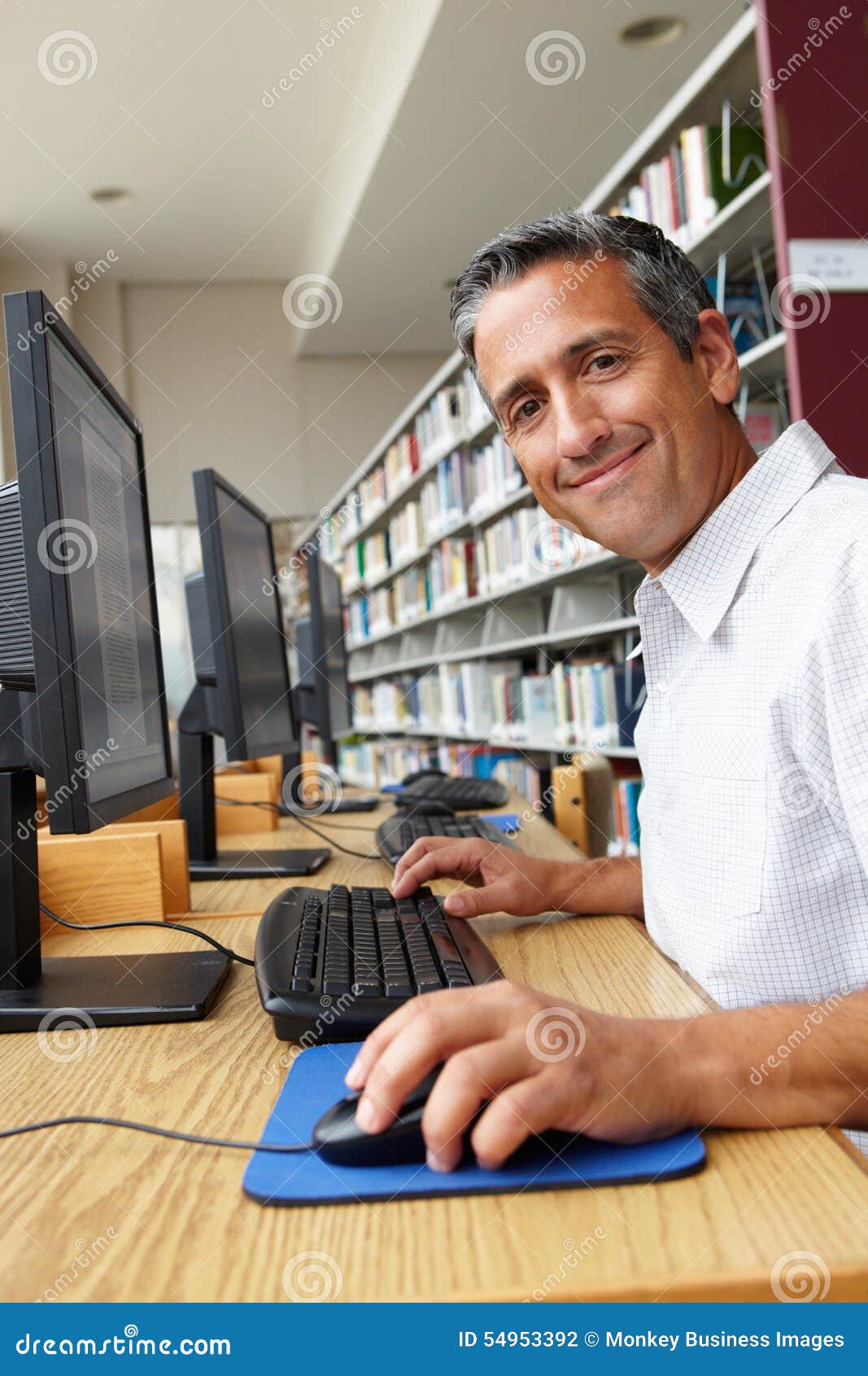 Man Working on Computer in Library Stock Photo - Image of degree ...