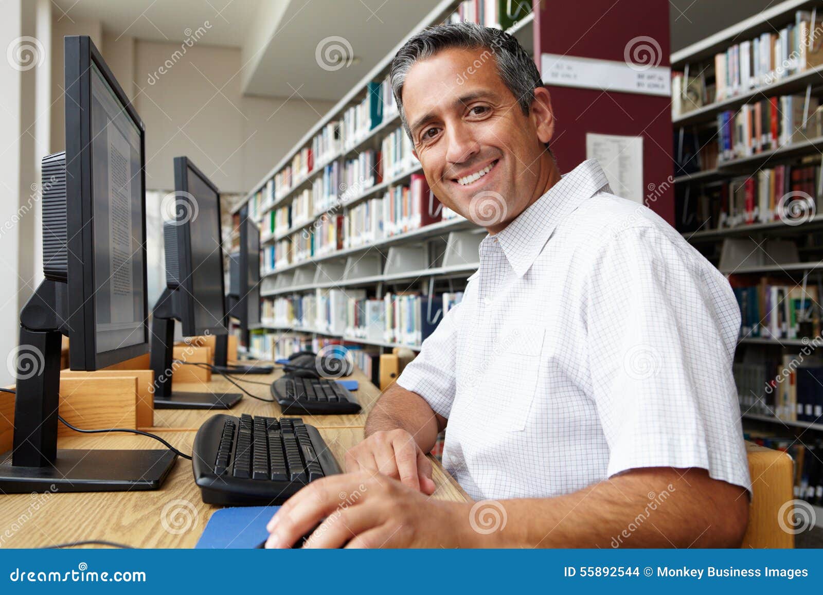 Man Working on Computer in Library Stock Photo - Image of indoors ...
