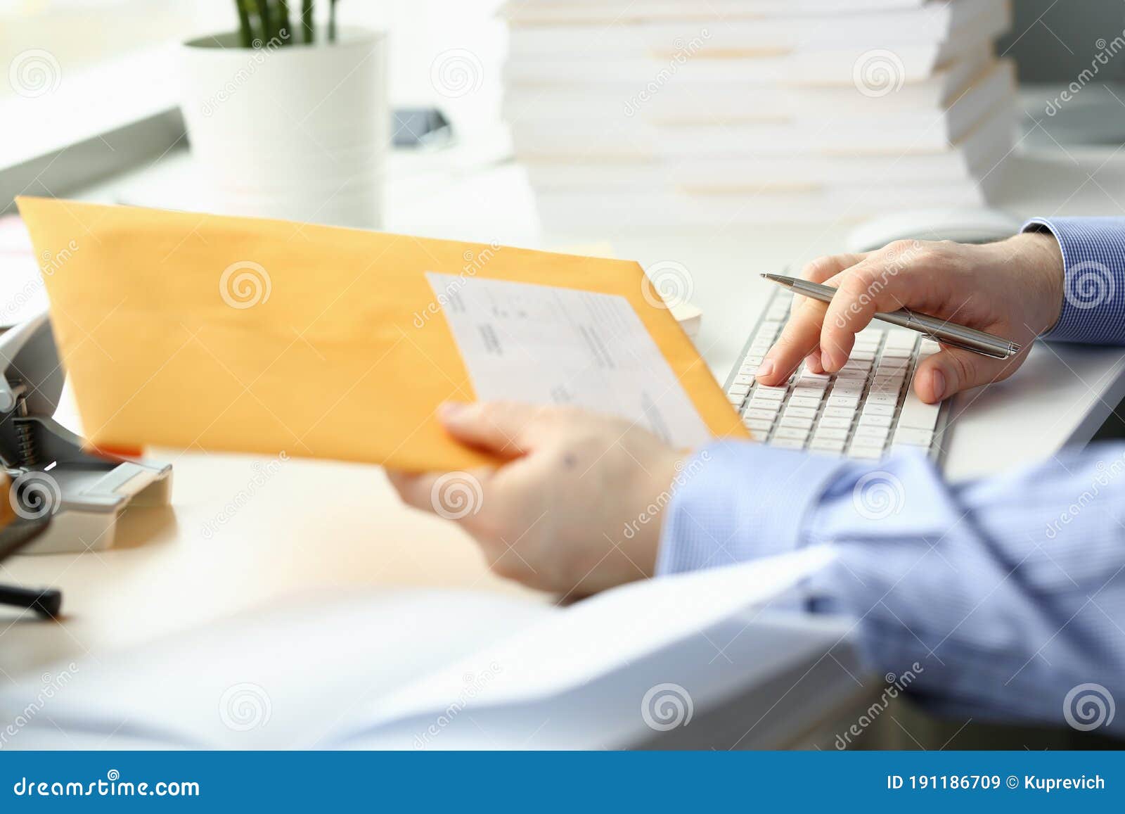 Man Working with Computer and Papers in Office Stock Image - Image of ...