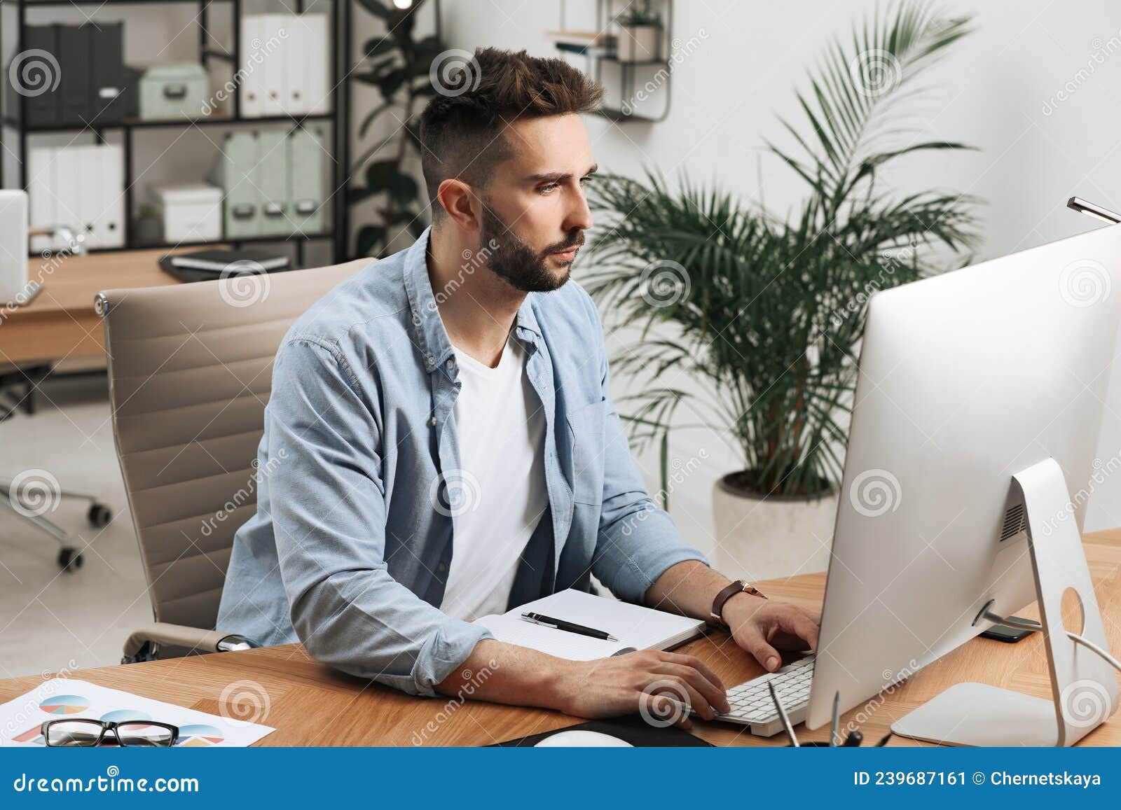 Man Working on Computer at Table in Office Stock Image - Image of ...