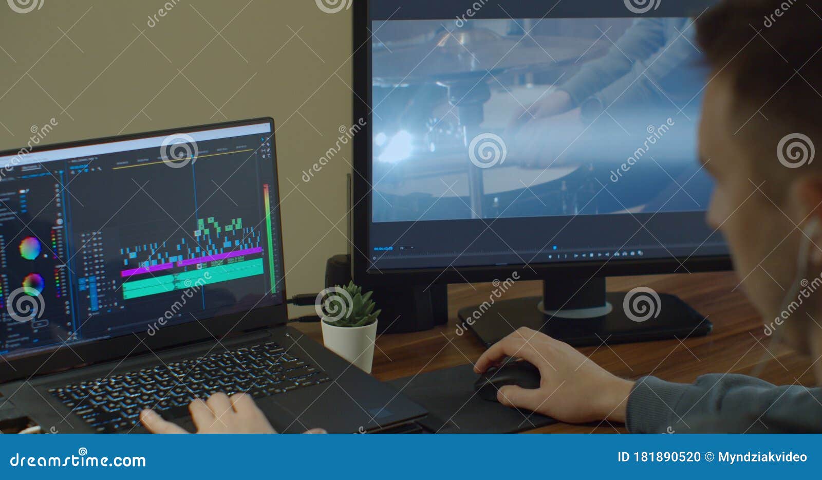 Man Working on Computer with Two Monitors Video Editing. Monitor the ...