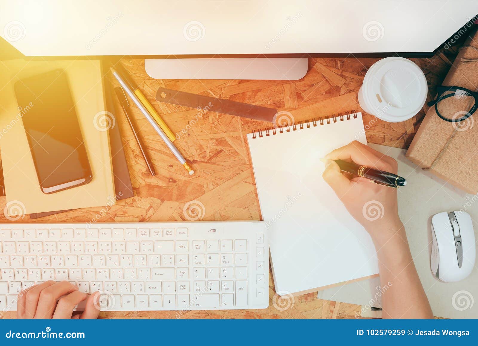 Man Working with Computer Typing Keyboard and Writing Pen on Notebook ...