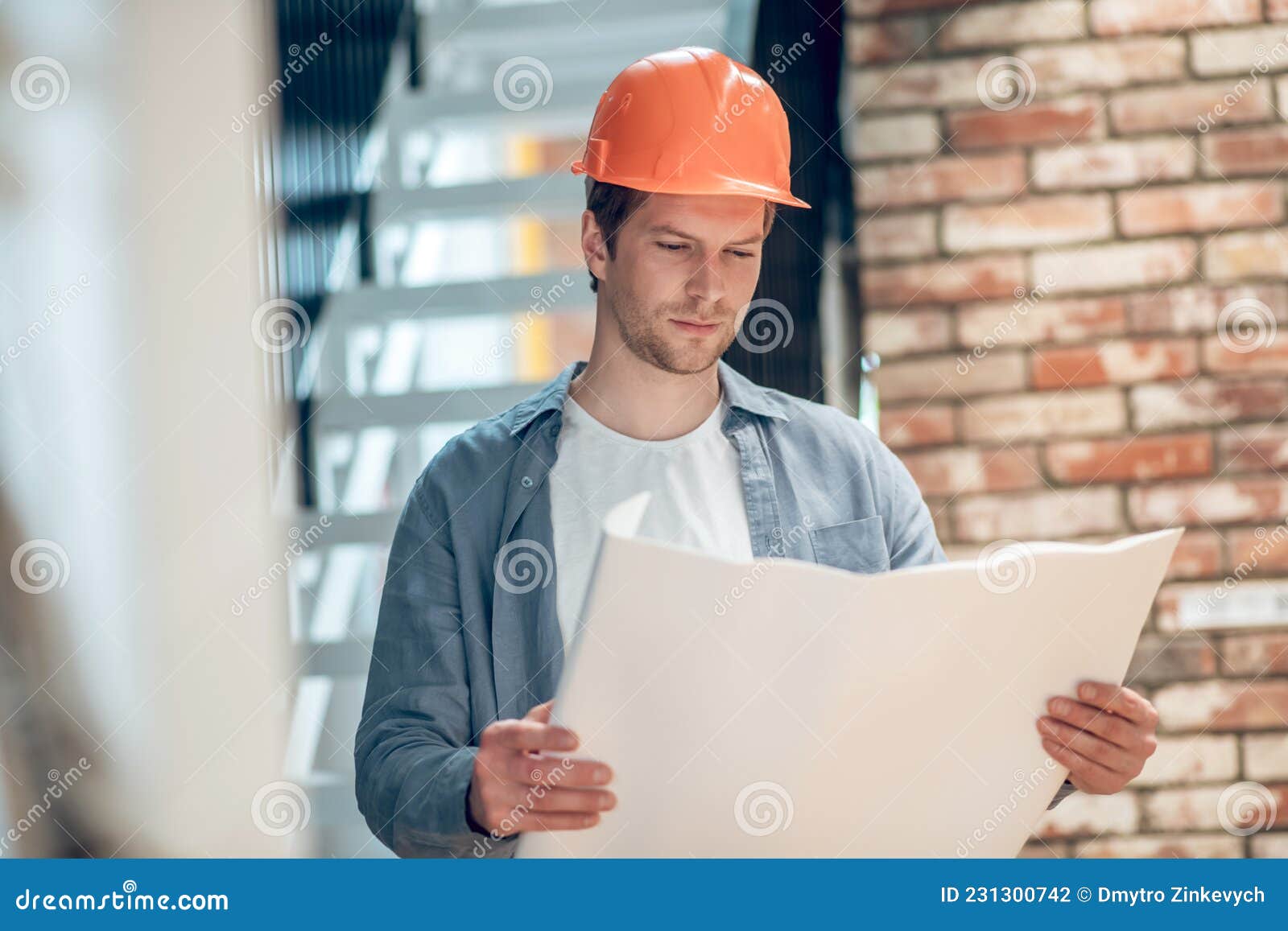 Man Working with Construction Plan at Building Feature Stock Photo ...