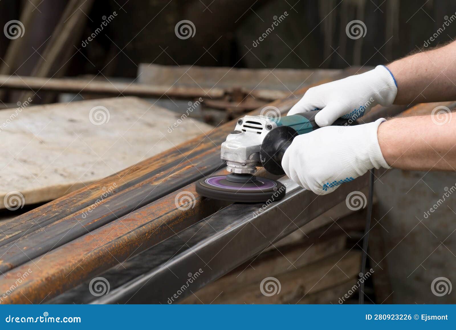 A Man Working with Electric Angle Grinder Tool. Removing Rust. Hands in ...