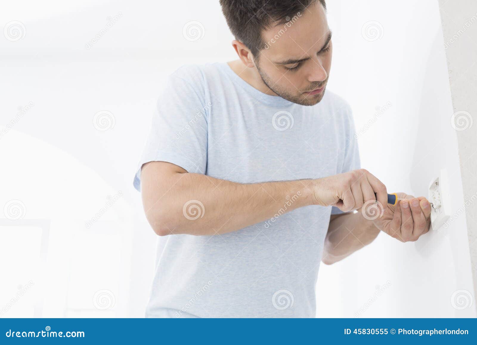 Man Working on Electrical Outlet Stock Image - Image of looking, home ...