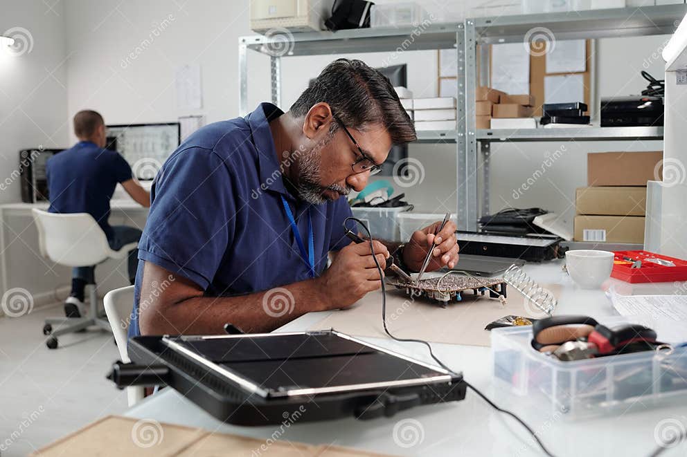 Man Working on Electronics at Modern Office Desk Stock Image - Image of ...