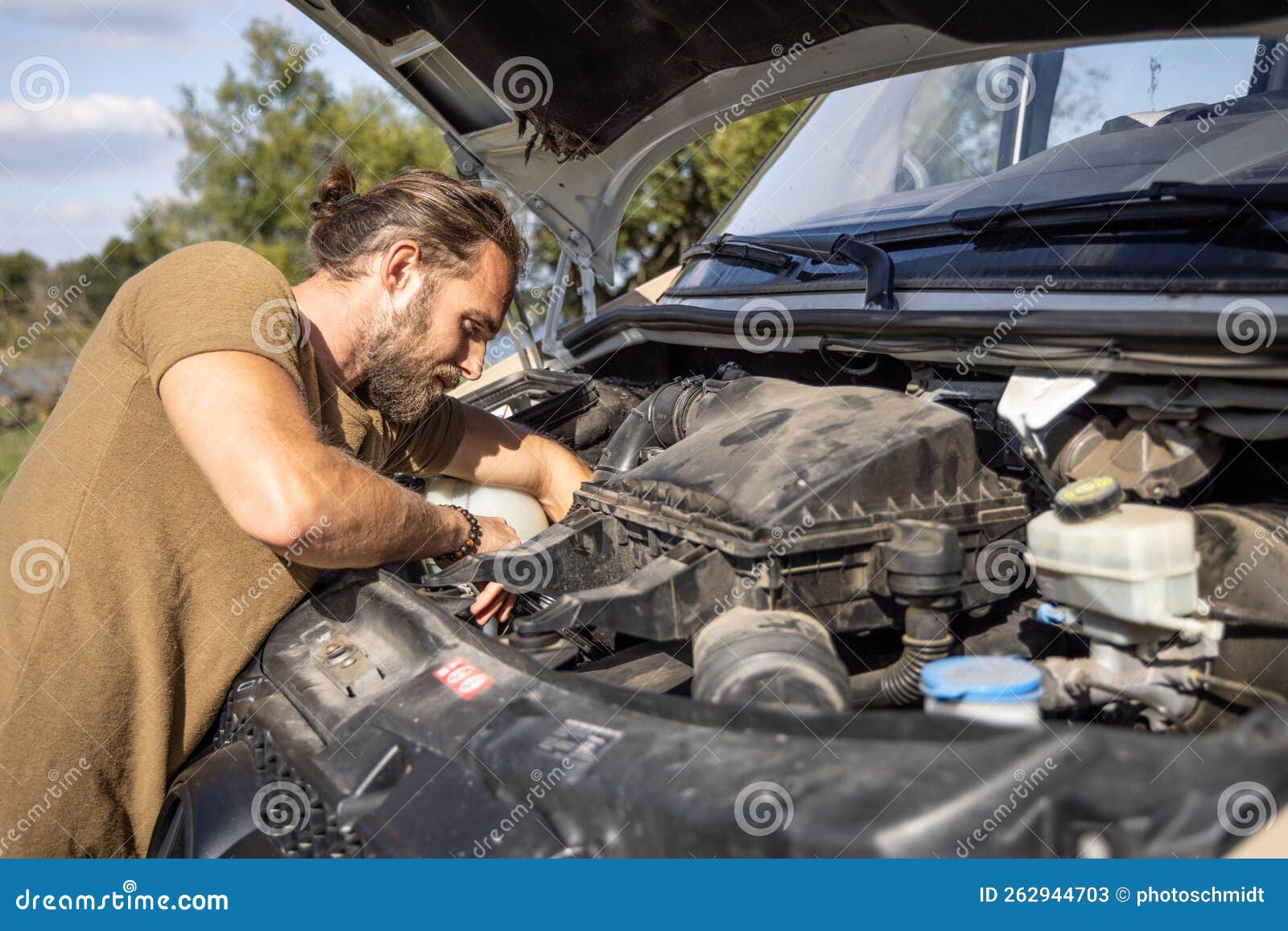 Man Working in the Engine Compartment of a Van Outdoors Stock Image ...