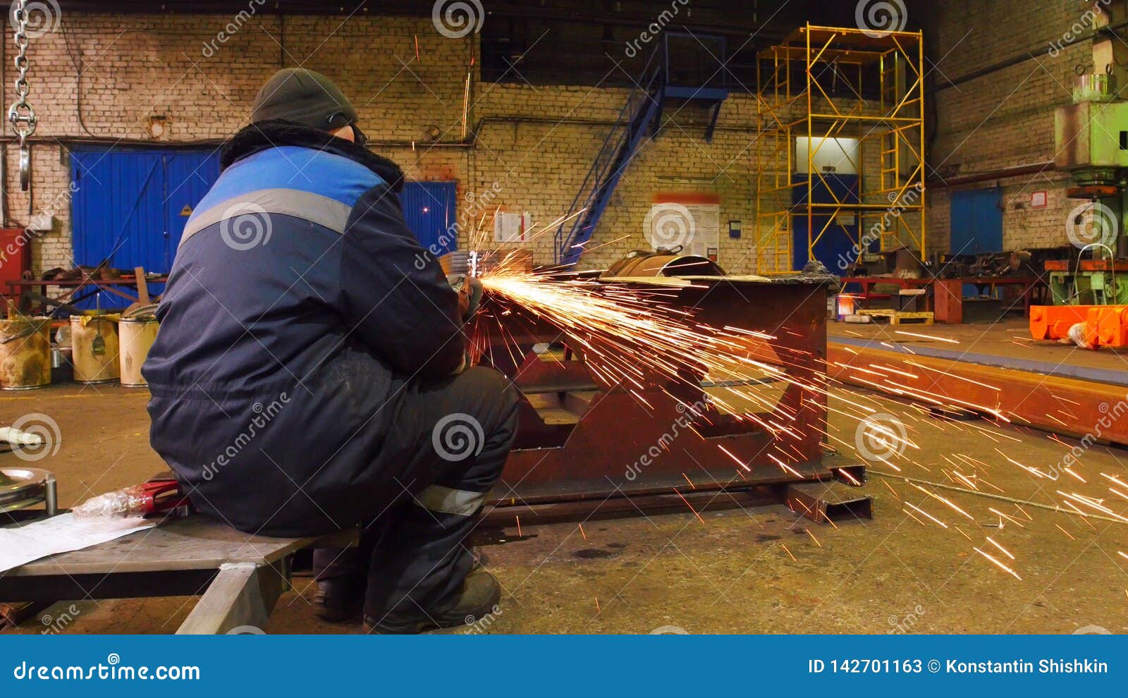 A Man Working with a Grinding Machine. Fire Sparkles Stock Image ...