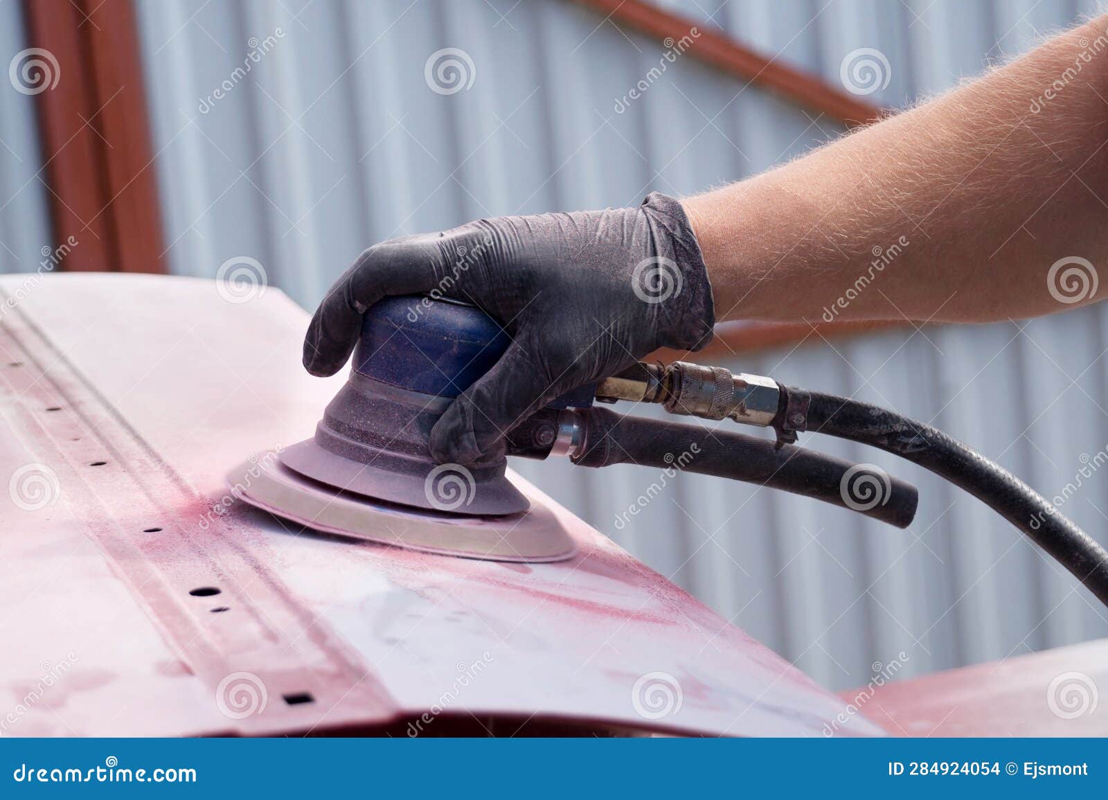 A Man Working with Grinding Tool. Sanding of Car Elements. Hands in ...