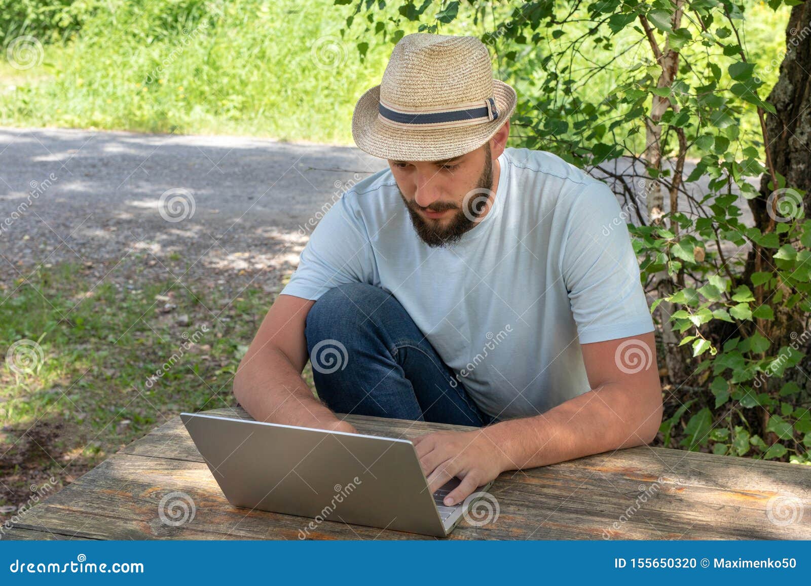 Man is Working Hard at a Computer in Nature. the Concept of Remote Work ...