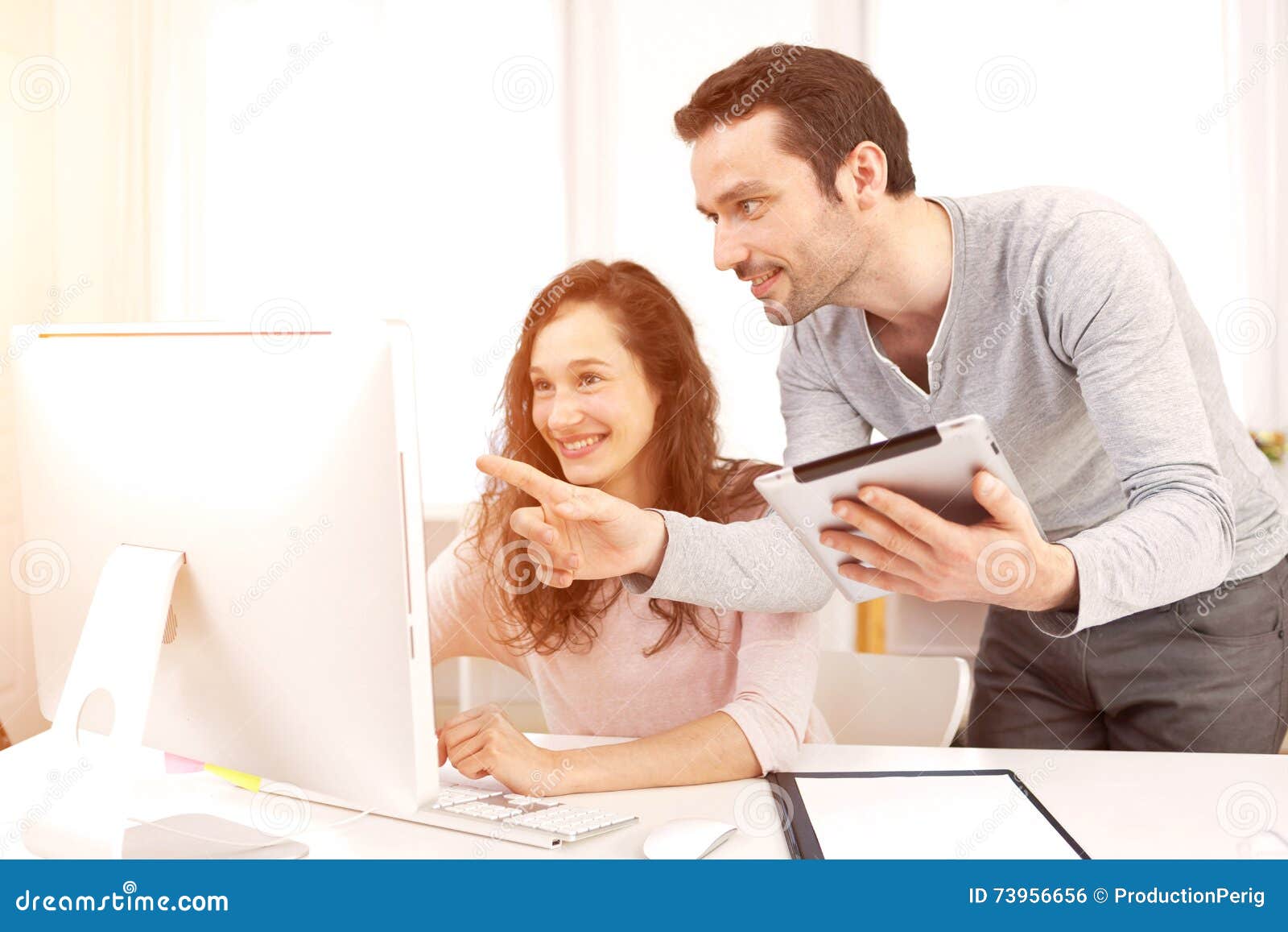 Man Working with His Co-worker on Computer Stock Photo - Image of ...