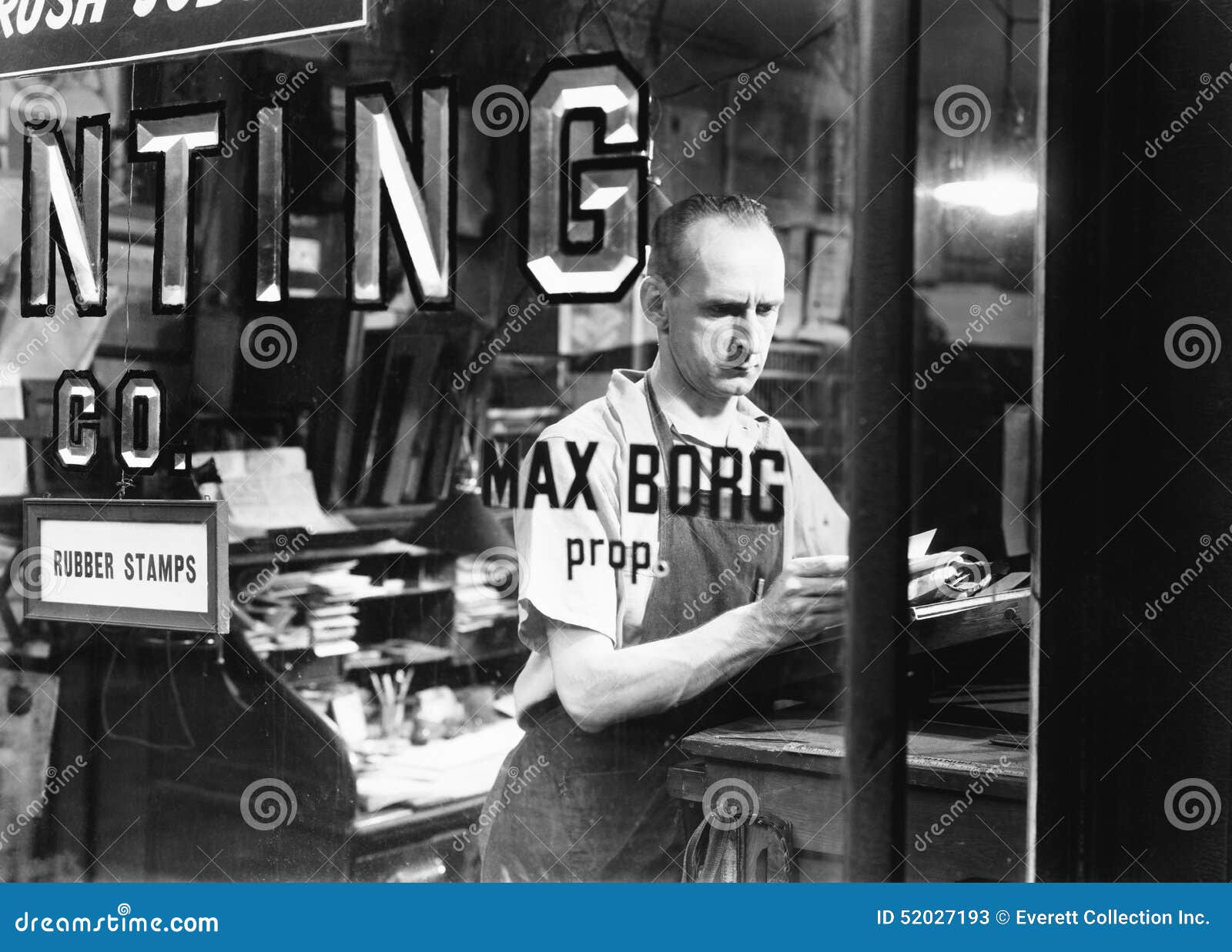 Man working in his store stock image. Image of aprons - 52027193