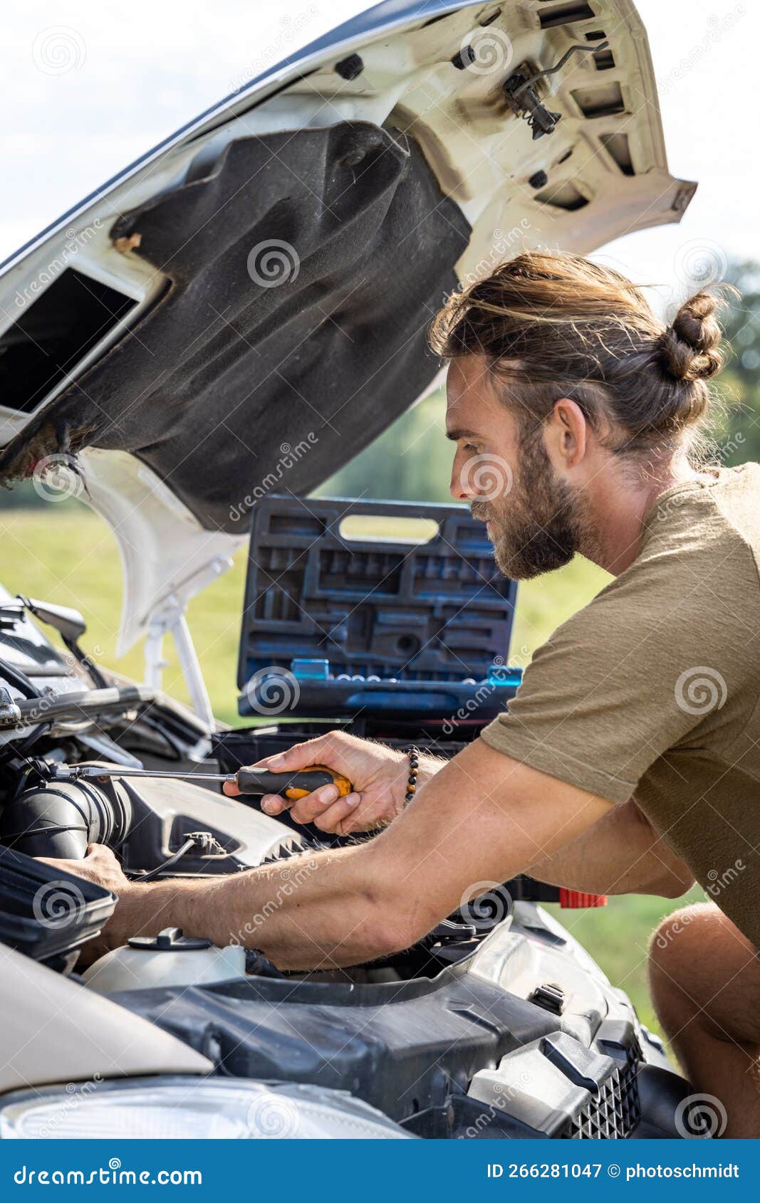 Man Working Inside the Engine Compartment of a Van Outdoors Stock Image ...