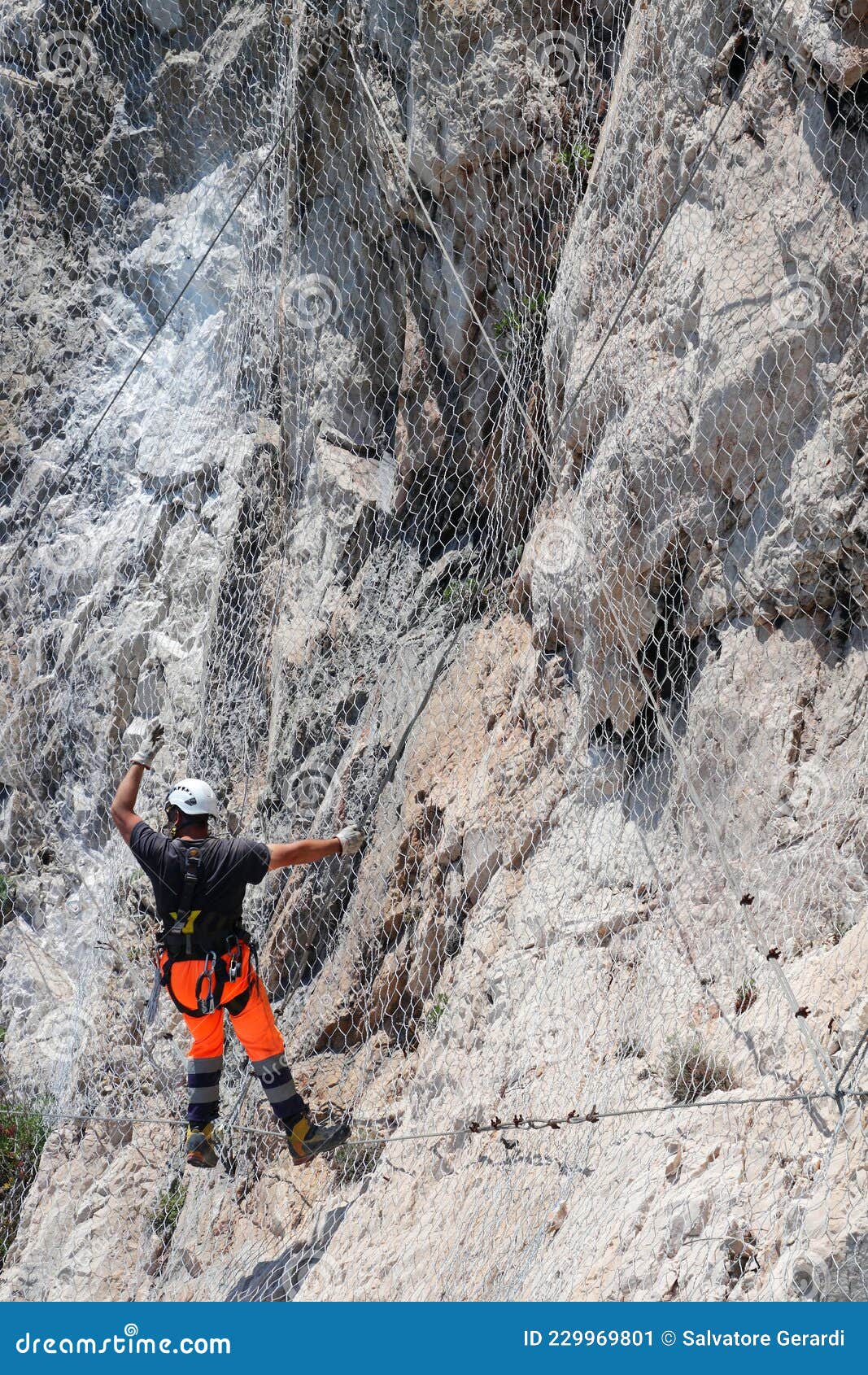 Man Working on the Installation of a Rockfall Protection Mesh Editorial ...