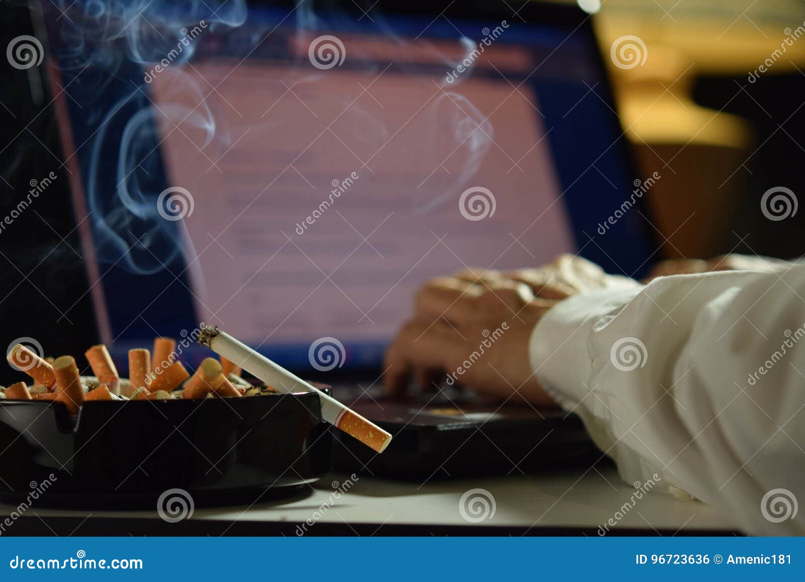 Man Working on Laptop Computer with Lit and Smoking Cigarette Stock ...