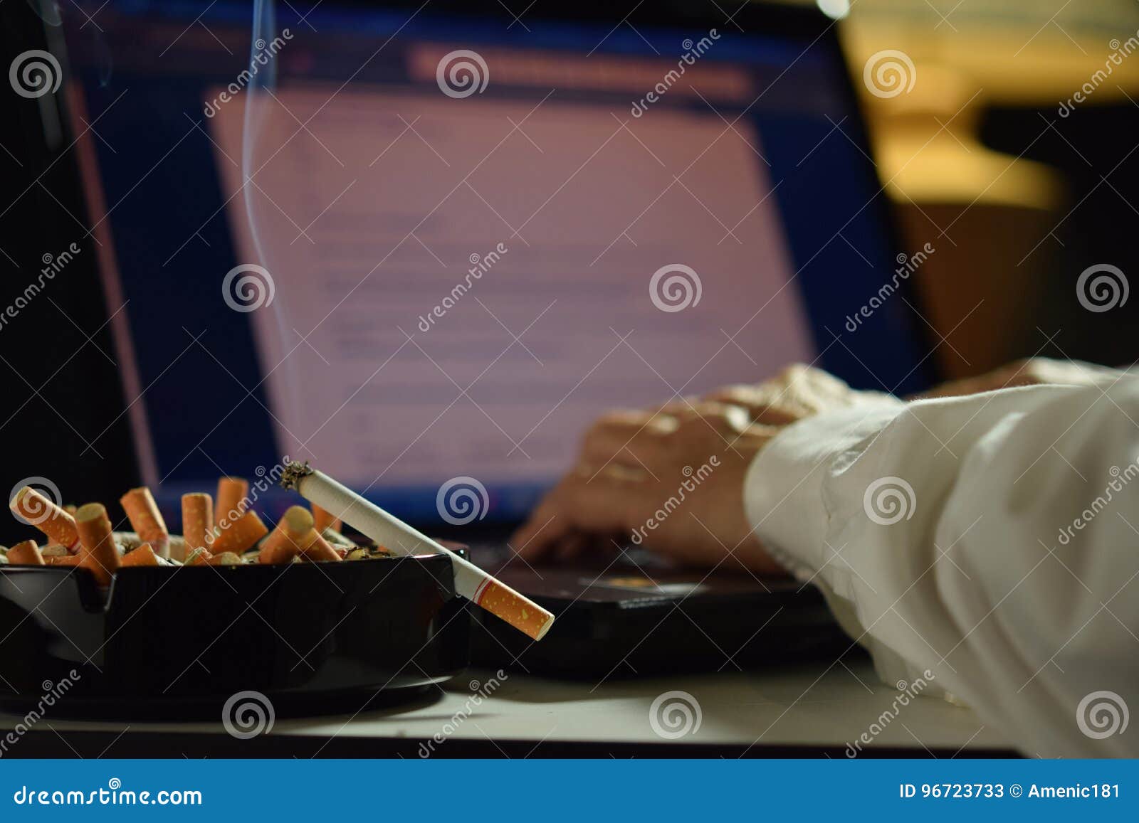 Man Working on Laptop Computer with Lit and Smoking Cigarette Stock ...