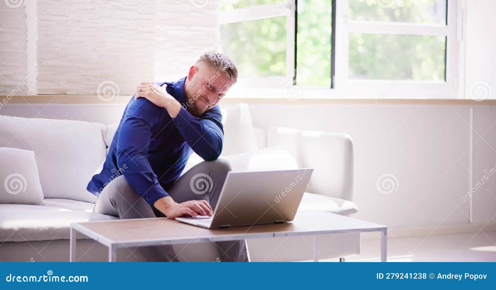 Man Working on Laptop Computer with Shoulder Injury Pain Stock Photo ...