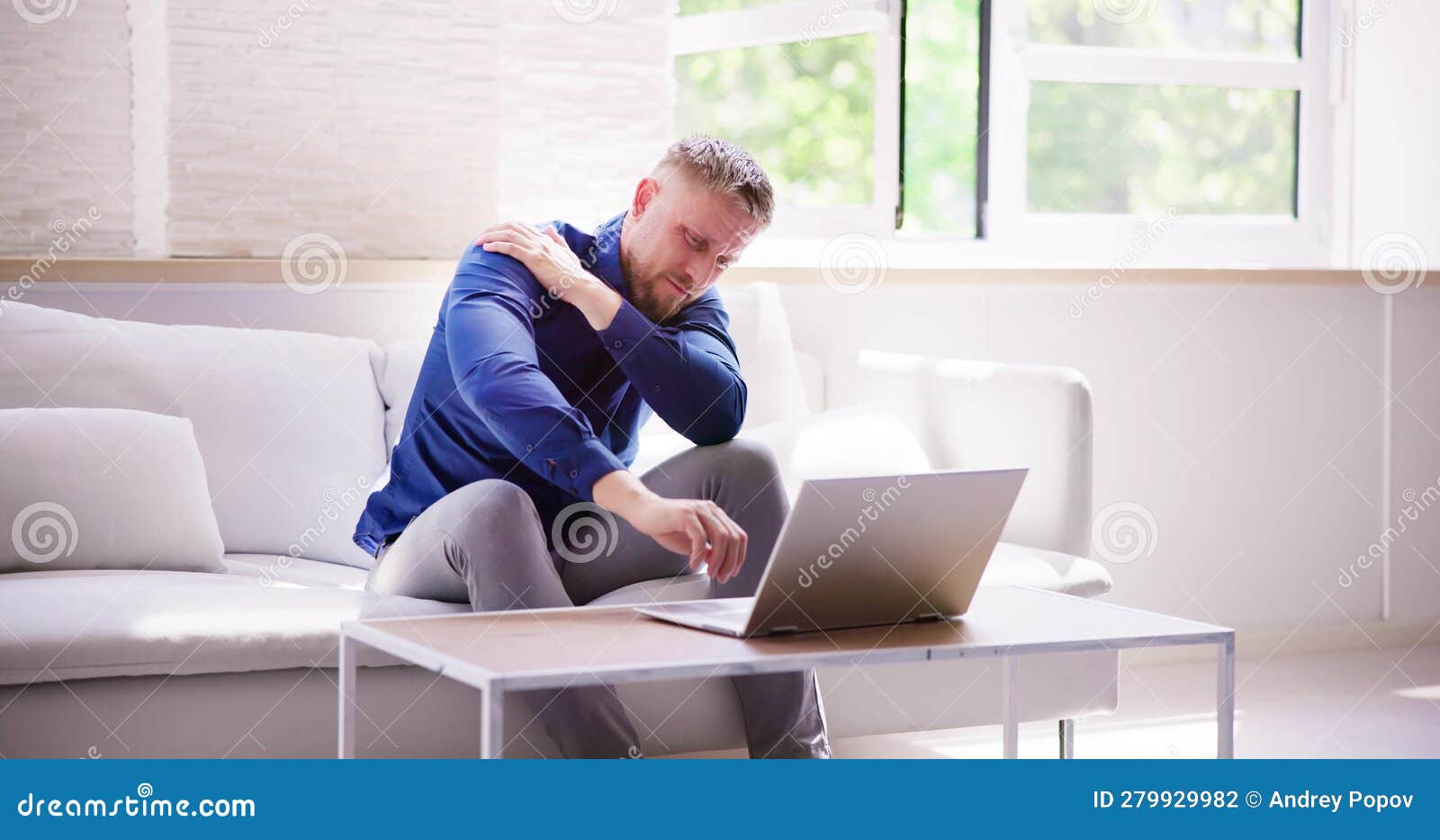 Man Working on Laptop Computer with Shoulder Injury Pain Stock Photo ...