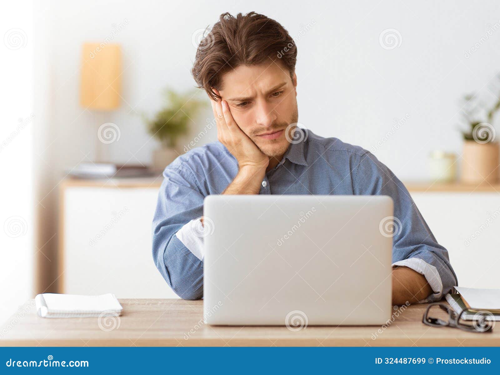 Man Working on Laptop with Concerned Expression Stock Image - Image of ...