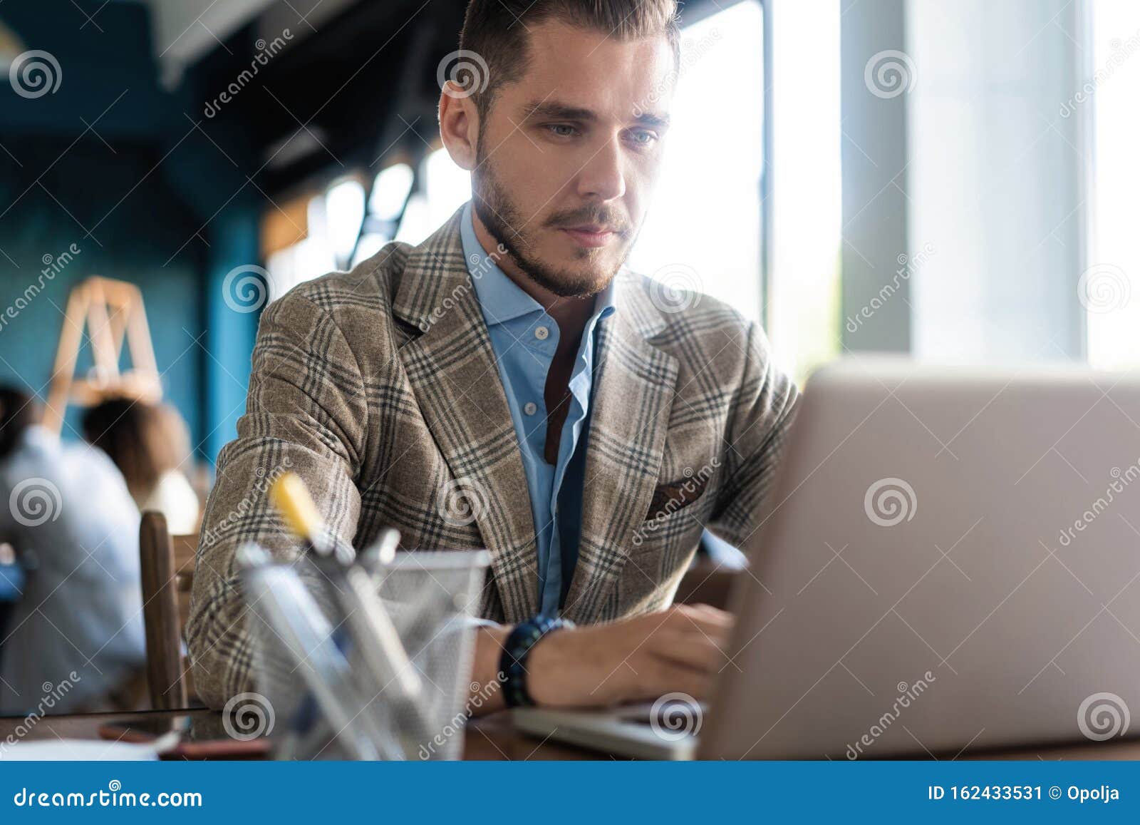 Man Working at Laptop in Contemporary Office Stock Image - Image of ...