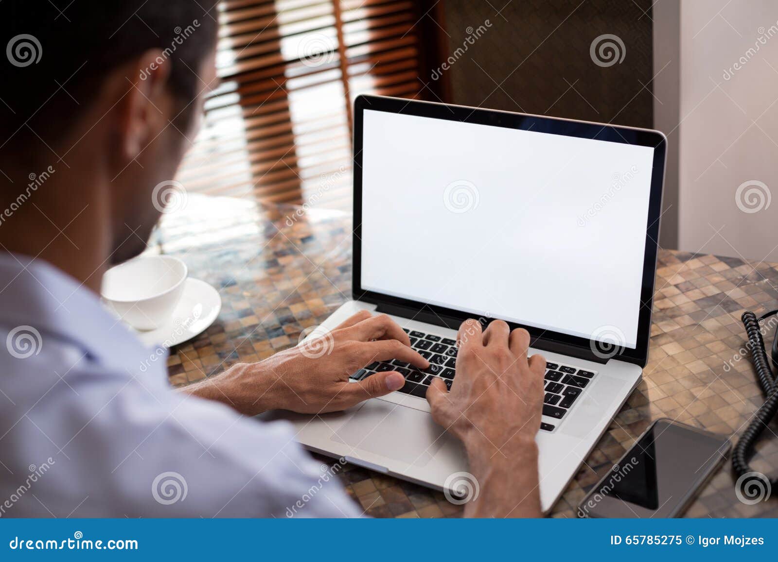 Man working on laptop stock image. Image of interior - 65785275