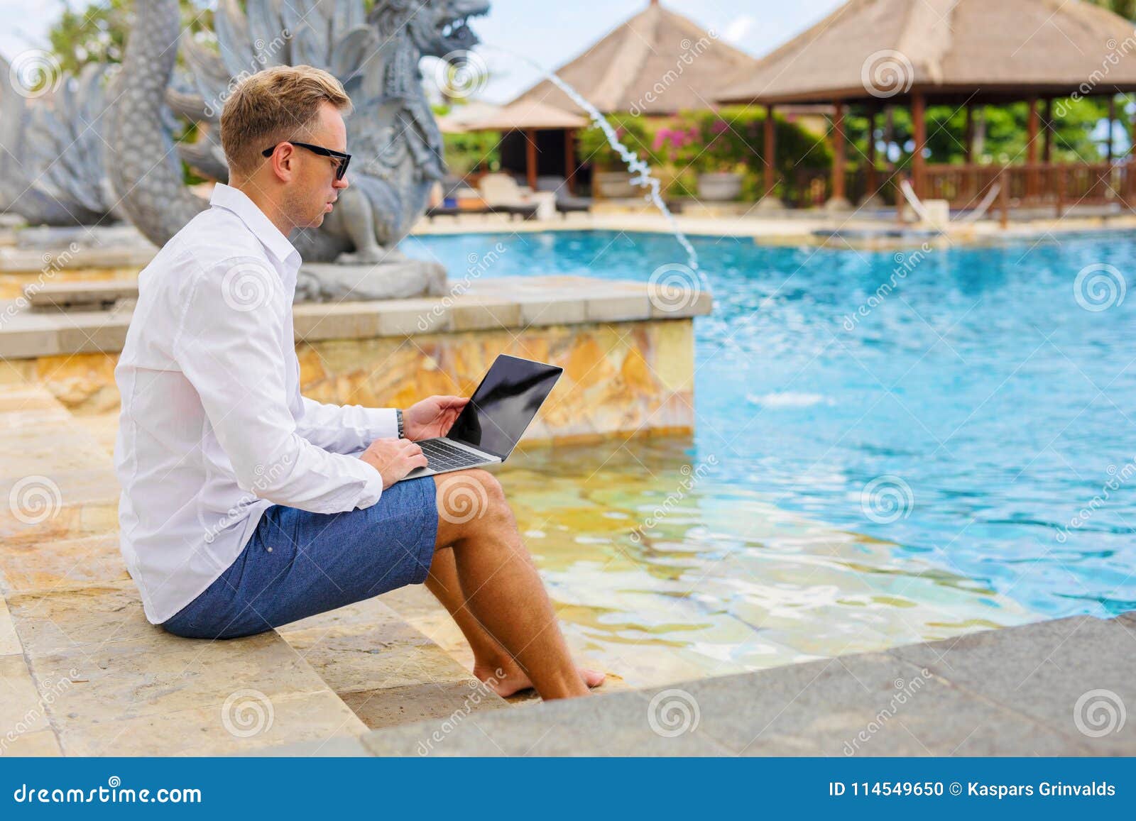 Man Working on Laptop by the Pool Stock Photo - Image of location ...