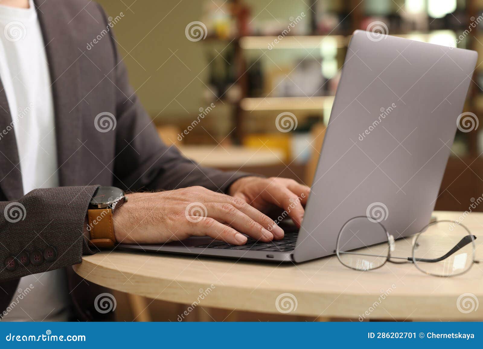 Man Working on Laptop at Table in Cafe, Closeup Stock Image - Image of ...