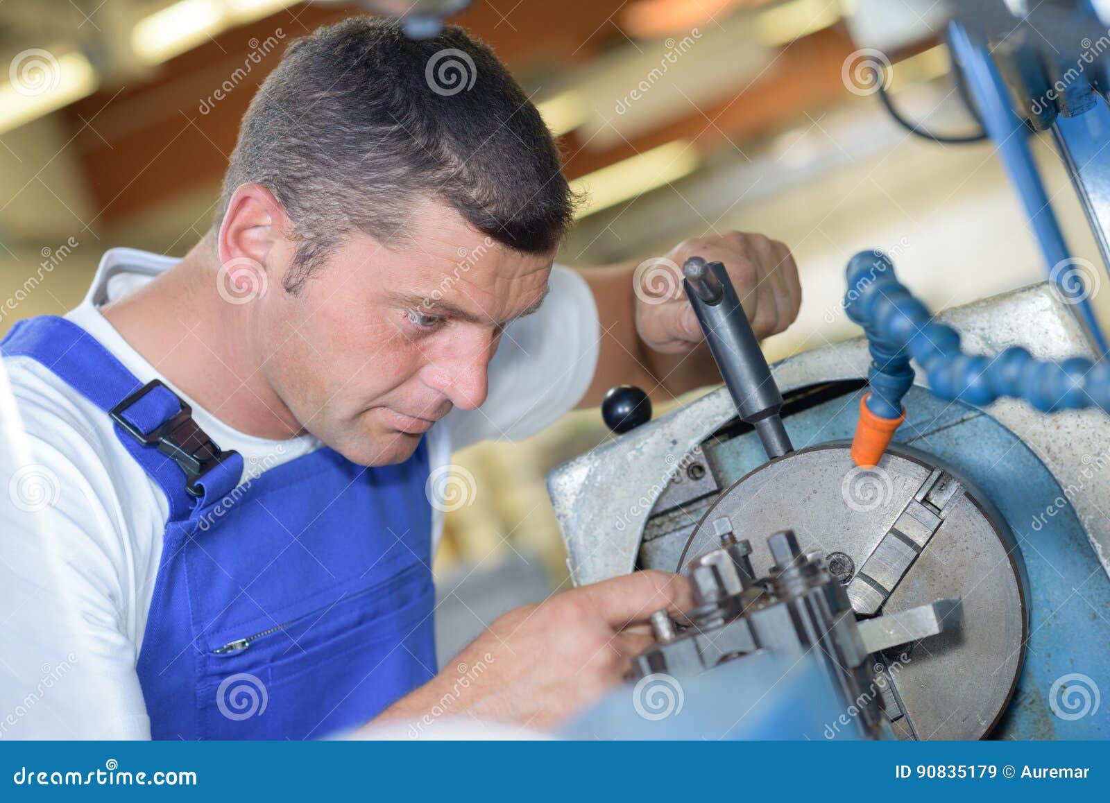 Man working on machine stock image. Image of factory - 90835179