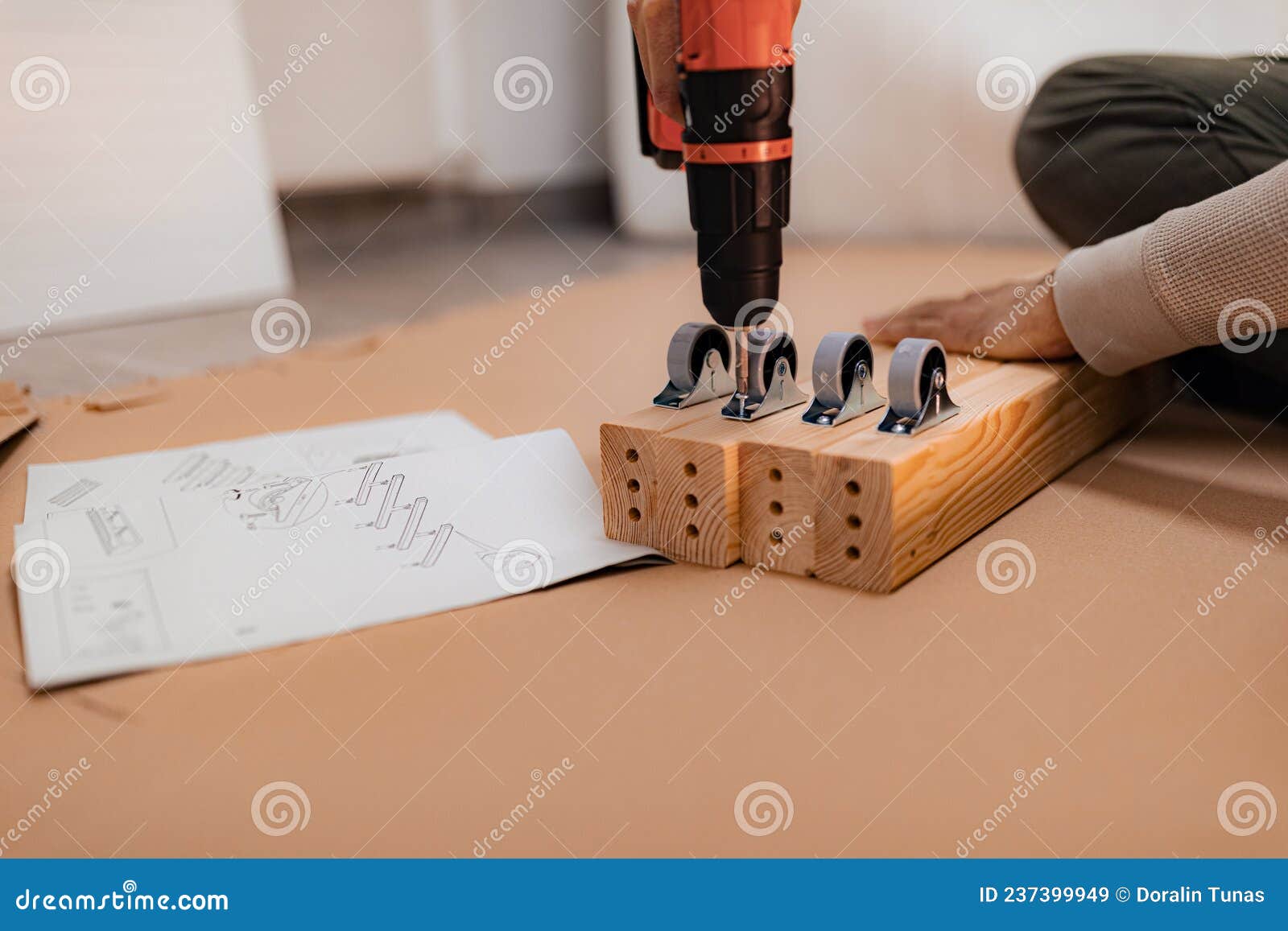 A Man Working on a New Bed Installation and Using a Cordless Drill ...